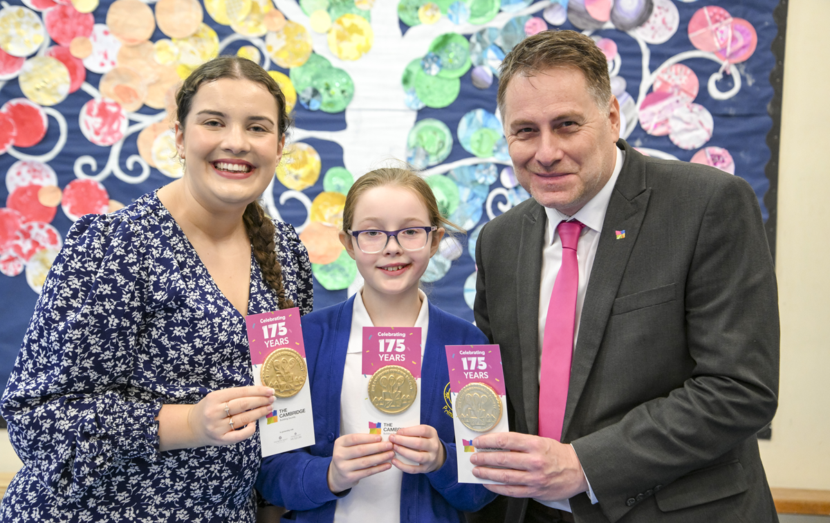 Erica delivers her winning chocolate coins to classmates